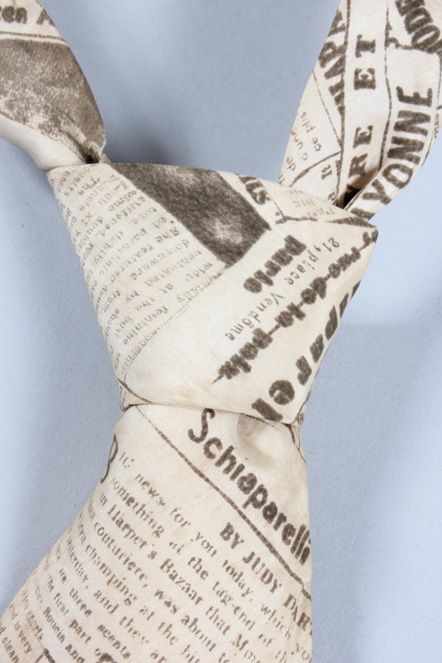 Lot 77 - A Schiaparelli newspaper-print silk tie for