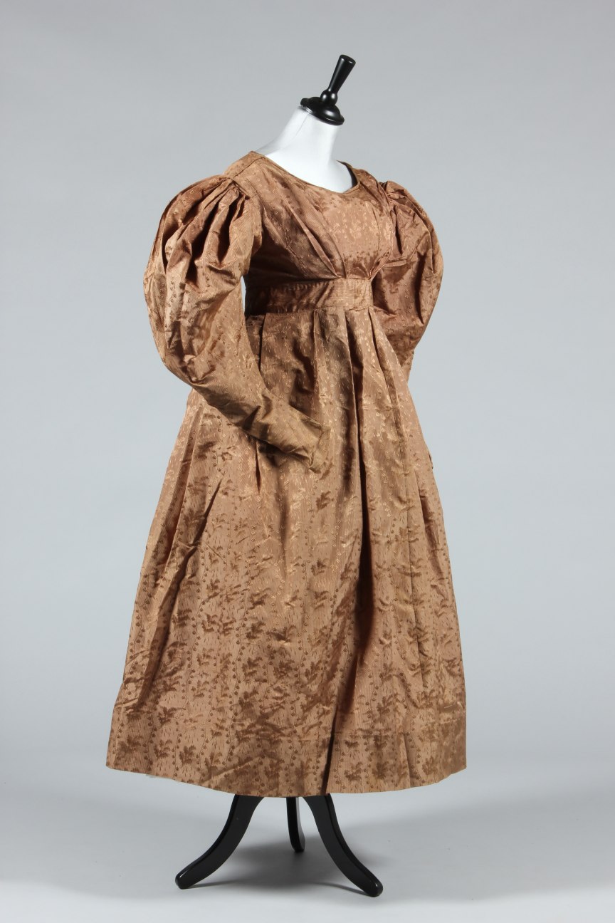 Lot 155 - A brown silk damask gown, circa 1830, with