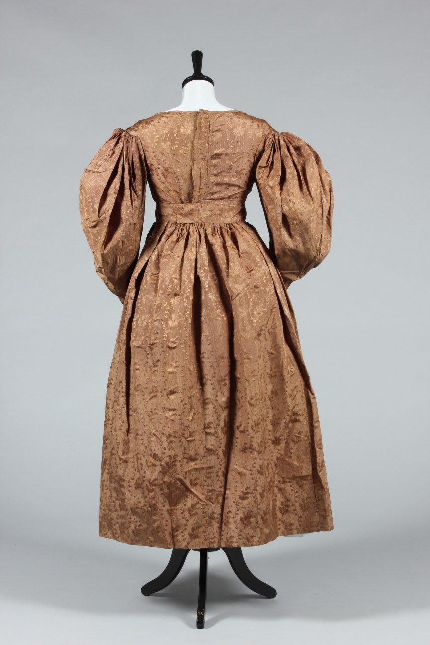 Lot 155 - A brown silk damask gown, circa 1830, with