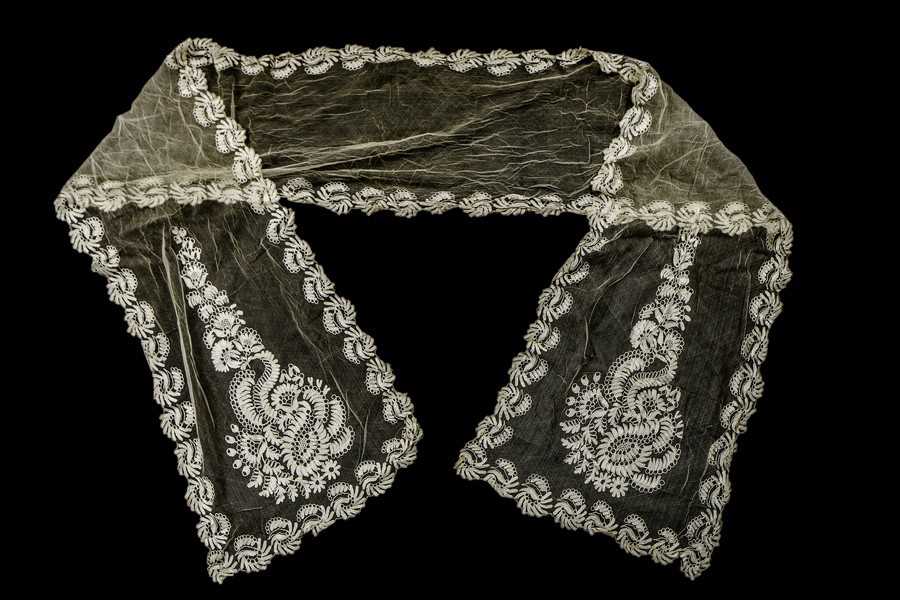 Lot 407 - An ecru tamboured net veil, circa 1900, with