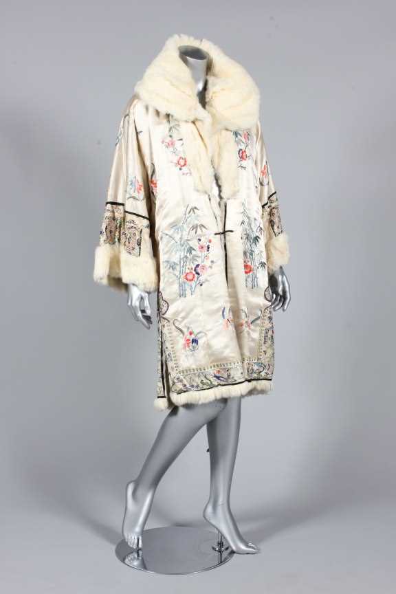 Lot 222 - An embroidered ivory satin evening coat,