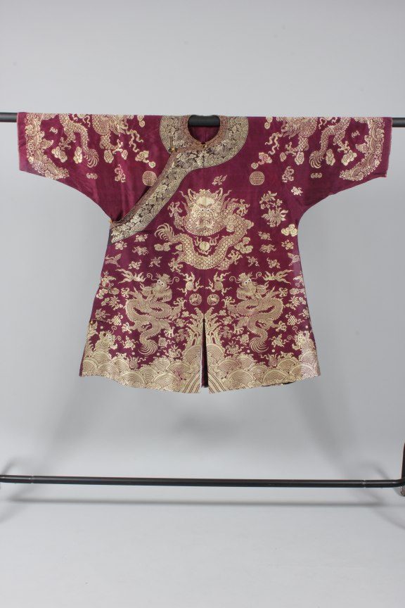 Lot 53 - A brocaded wine silk dragon robe, jifu, circa