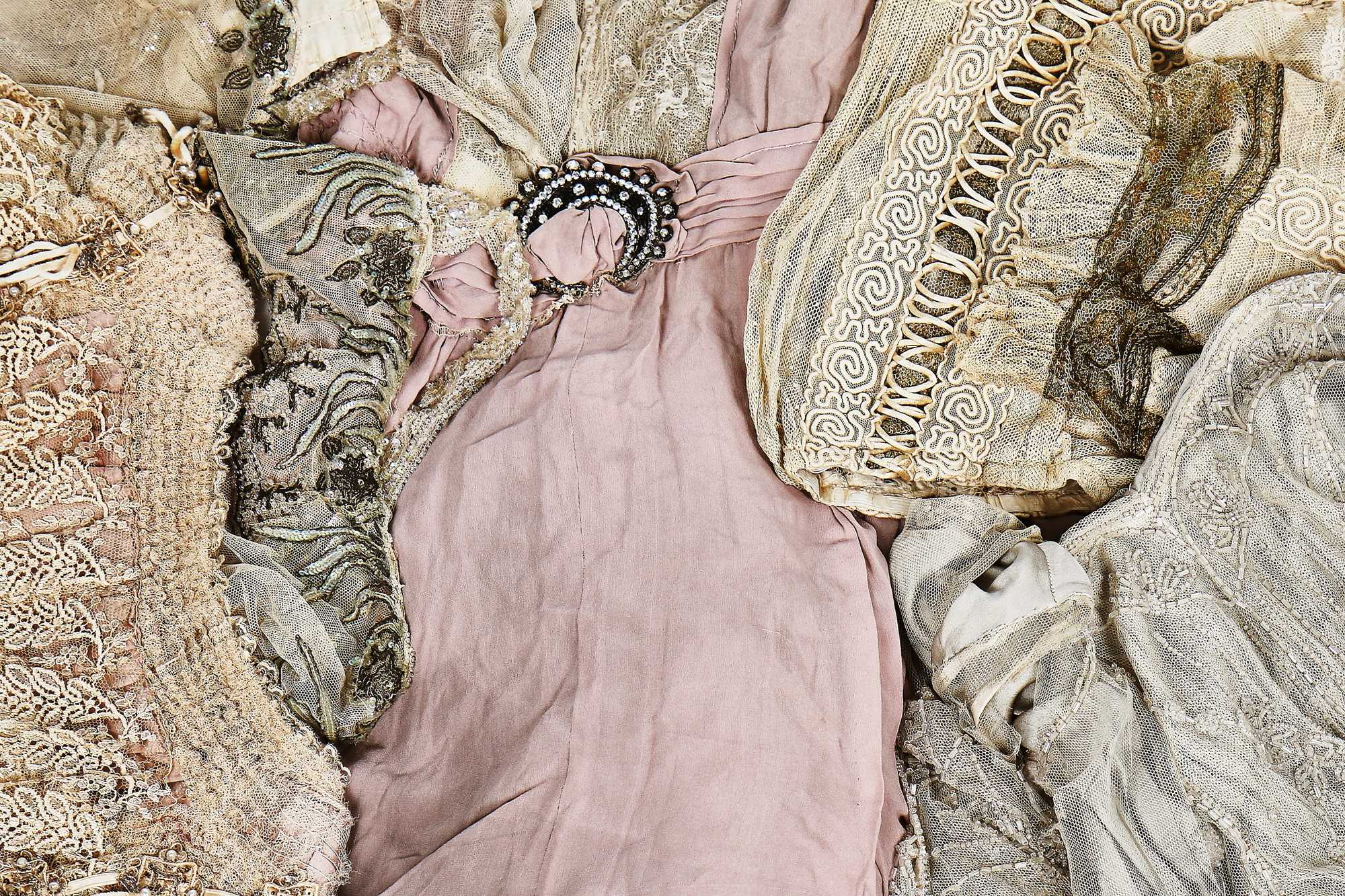 Lot 355 - A large box of damaged garments, mainly late
