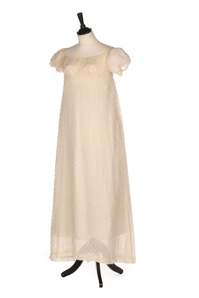 Lot 83 - A white muslin empire line dress, circa 1805,