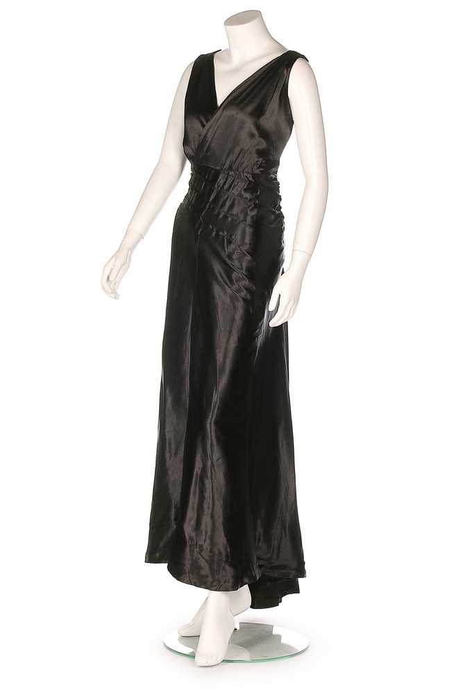Lot 124 - A Maison Worth couture black satin evening