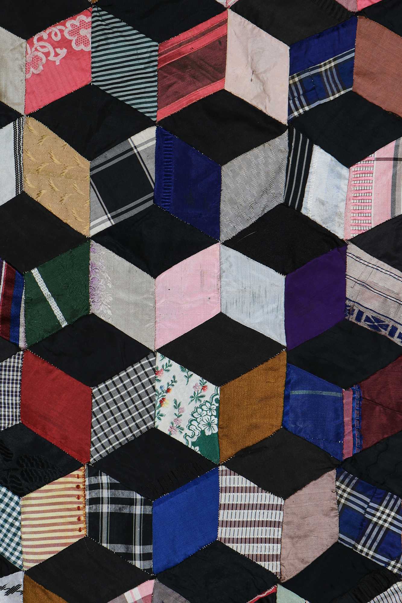 Lot 250 - A 'tumbling block' silk patchwork panel,