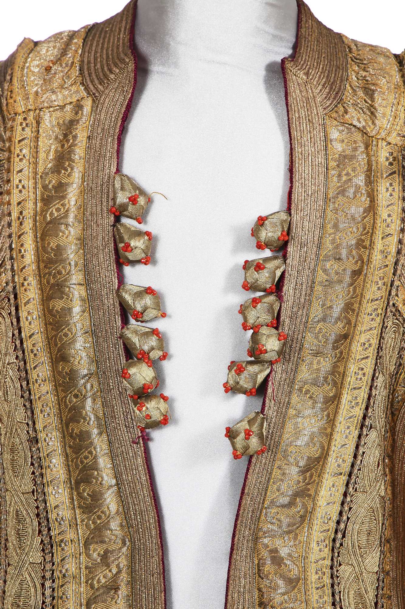 Lot 500 - An embroidered burgundy velvet surcoat,