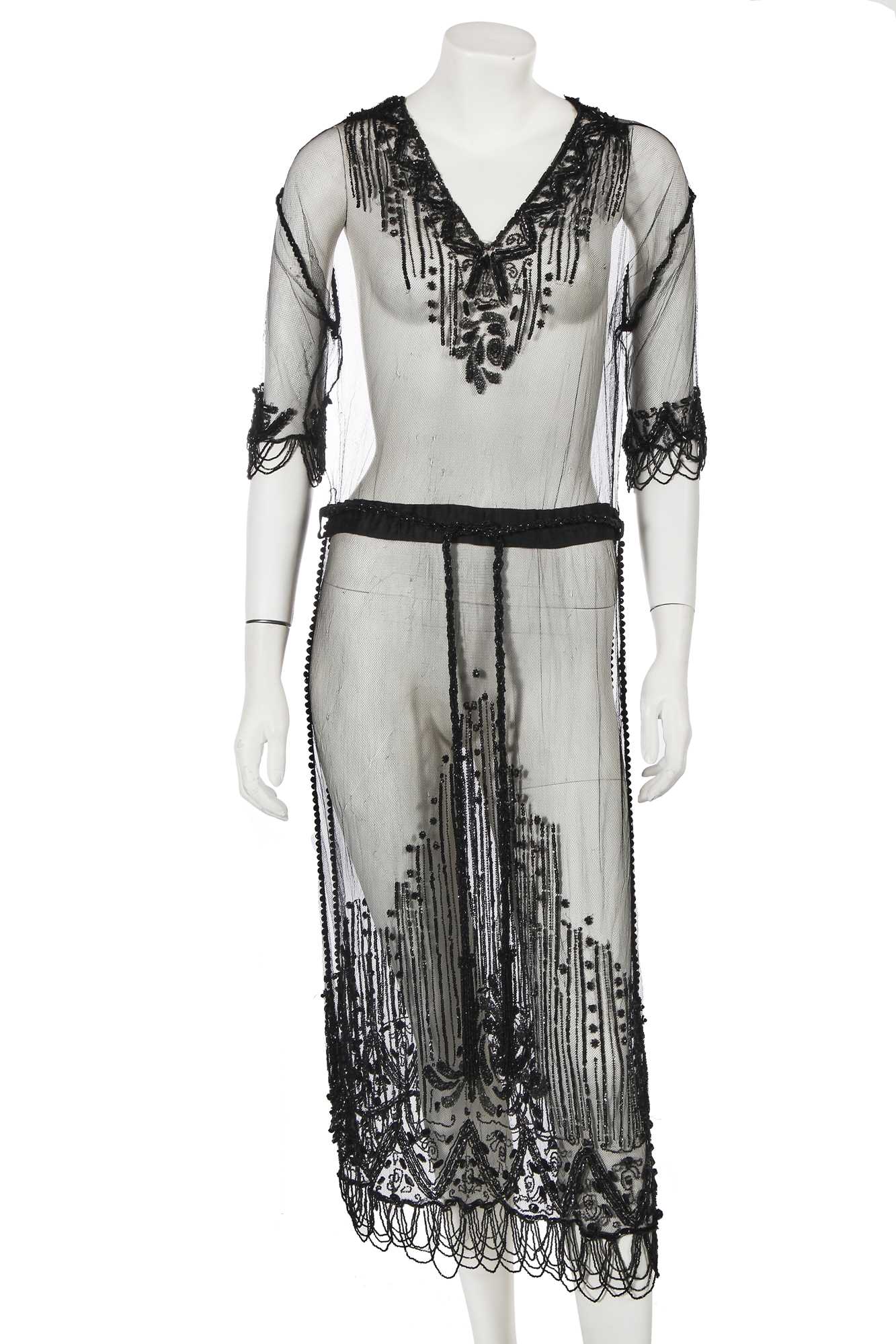 Lot 633 - A black beaded tulle tabard, circa 1915