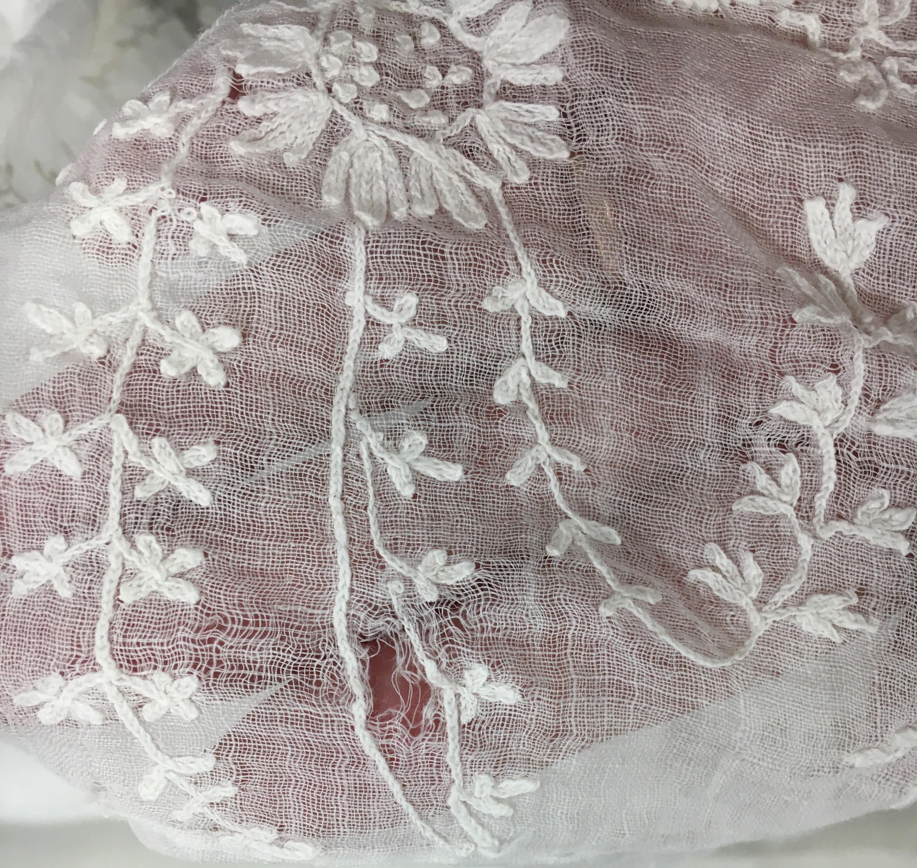 Lot 512 - An embroidered muslin frock with train,