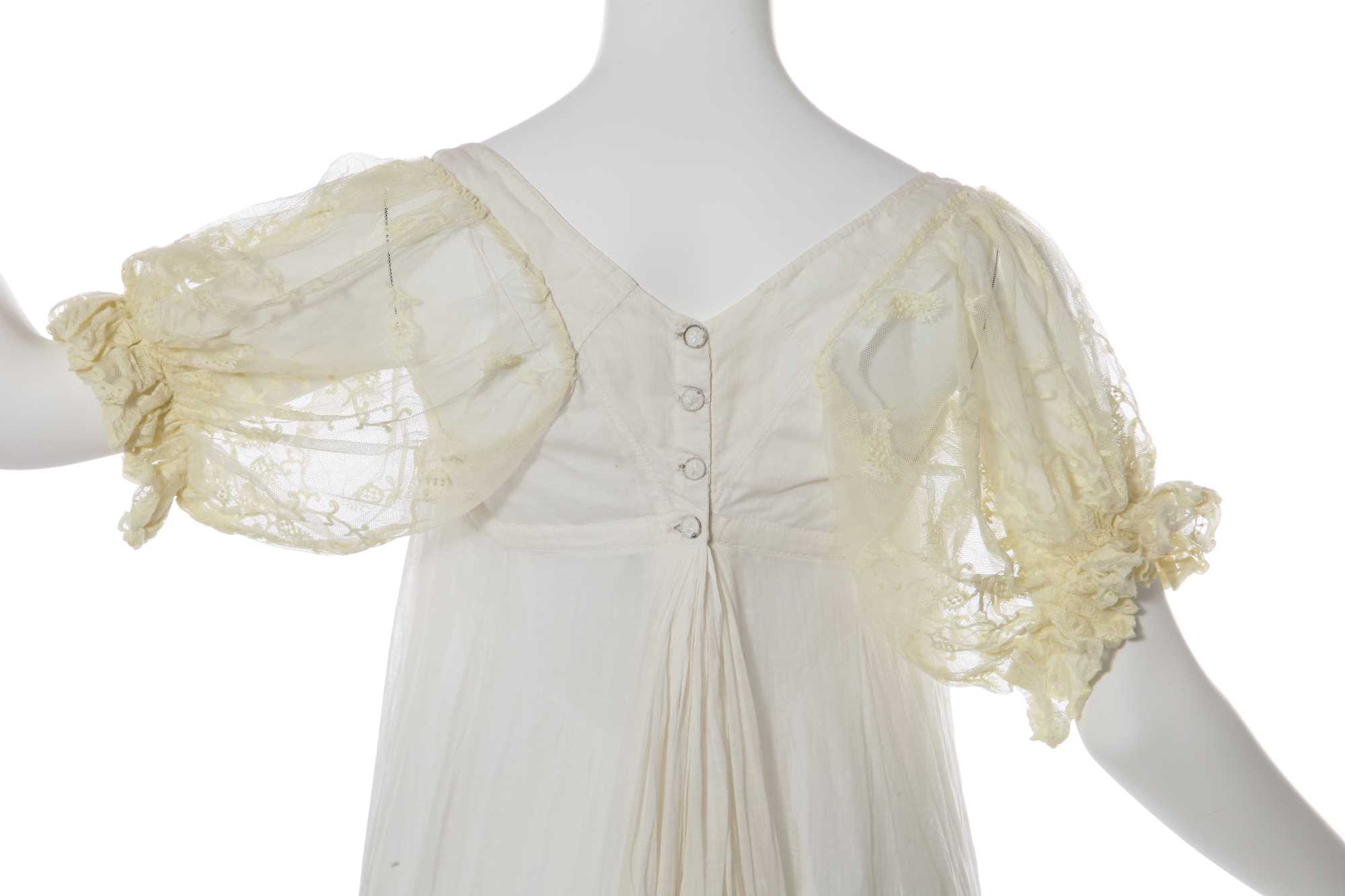 Lot 512 - An embroidered muslin frock with train,