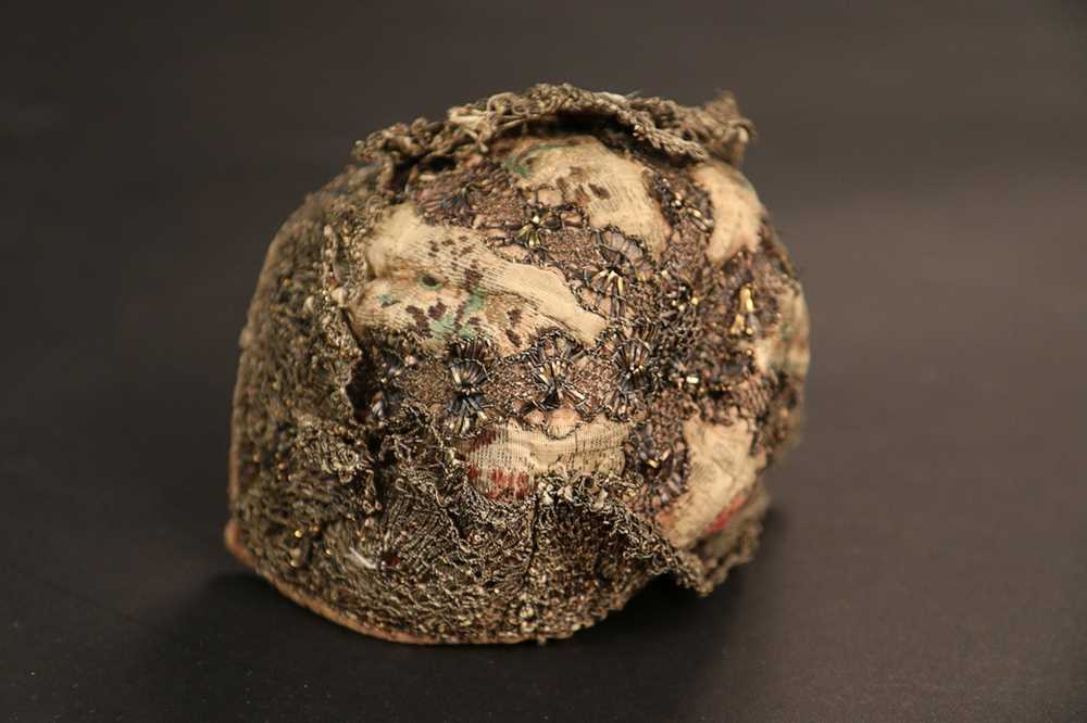 Lot 444 - A brocaded silk baby bonnet, circa 1750-60,