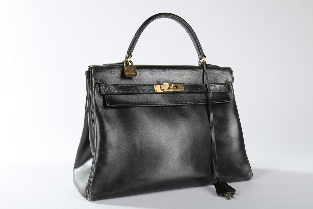 Lot 74 - An Hermès black leather Kelly bag, 1950s-60s,