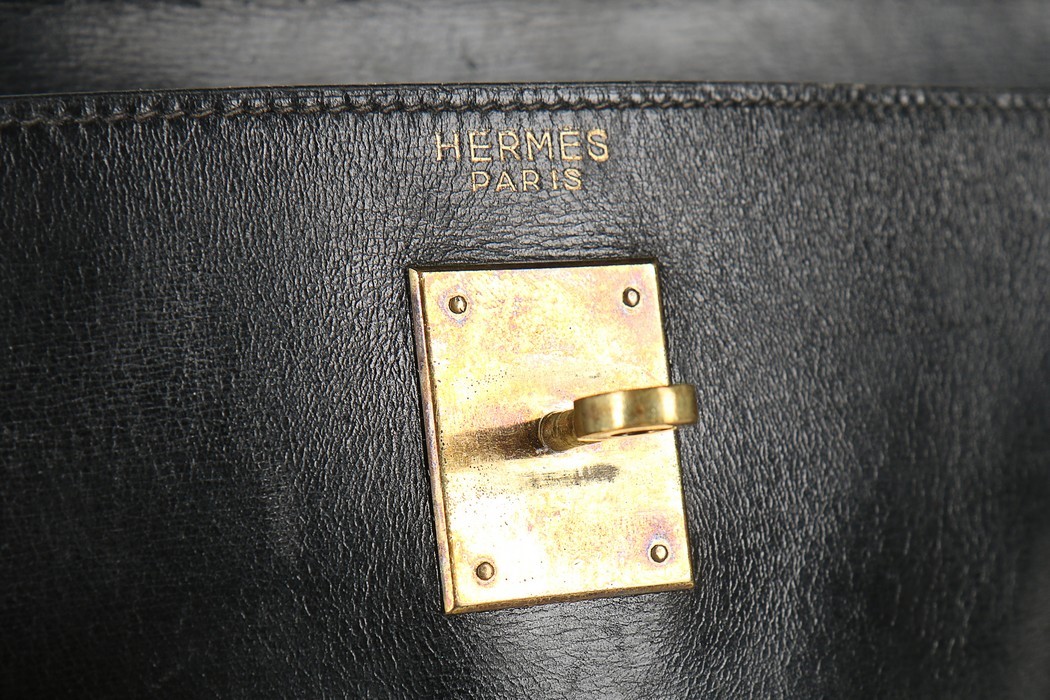 Lot 74 - An Hermès black leather Kelly bag, 1950s-60s,
