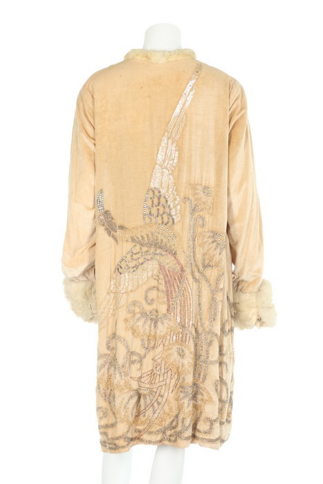 Lot 57 - A lavishly beaded ivory velvet opera coat,