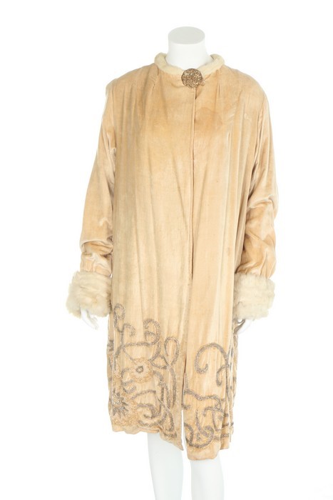 Lot 57 - A lavishly beaded ivory velvet opera coat,