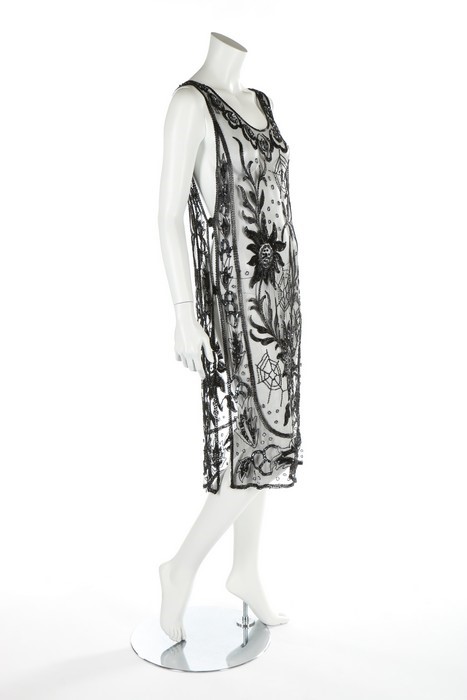 Lot 145 - A black tulle tabard, early 1920s, with