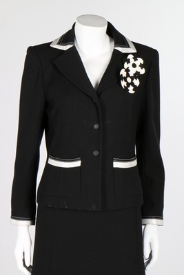 Lot 12 - A Chanel black wool suit with white satin
