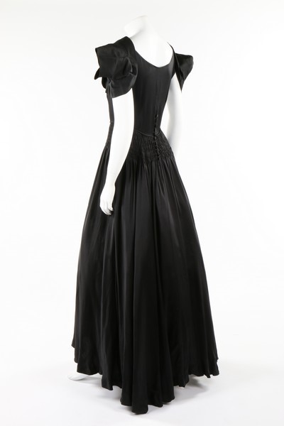Lot 50 - A Norman Hartnell couture black satin dress,