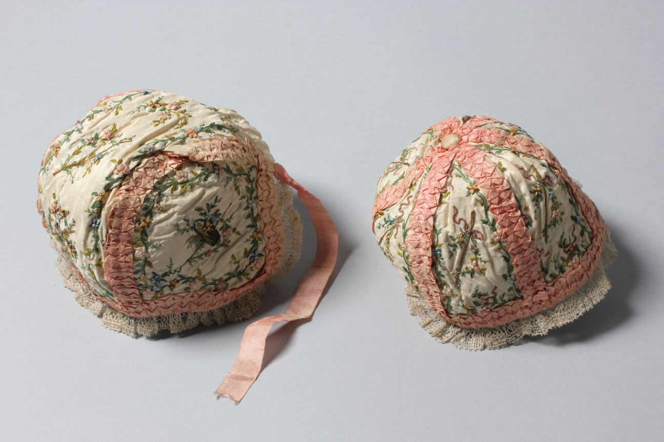 Lot 151 - Two silk baby bonnets, French, late 18th