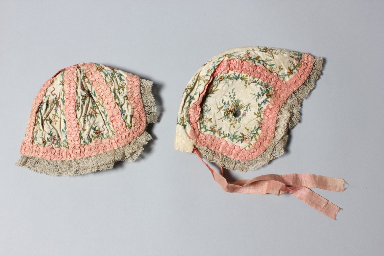 Lot 151 - Two silk baby bonnets, French, late 18th
