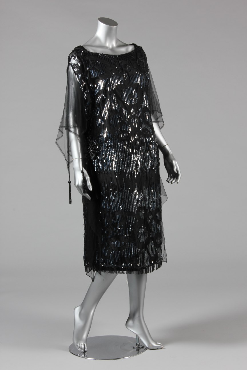 Lot 11 - A sequinned black tulle tabard dress, early