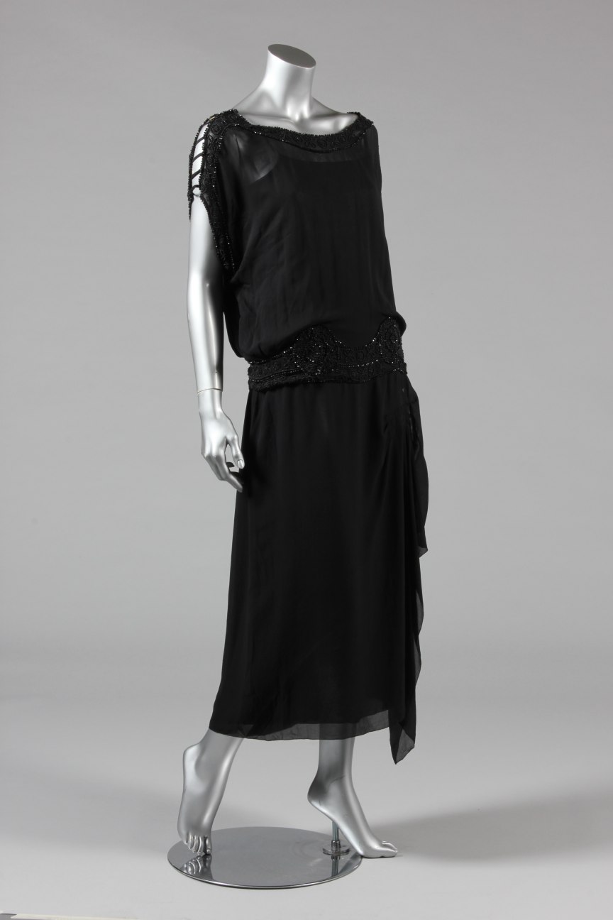 Lot 11 - A sequinned black tulle tabard dress, early