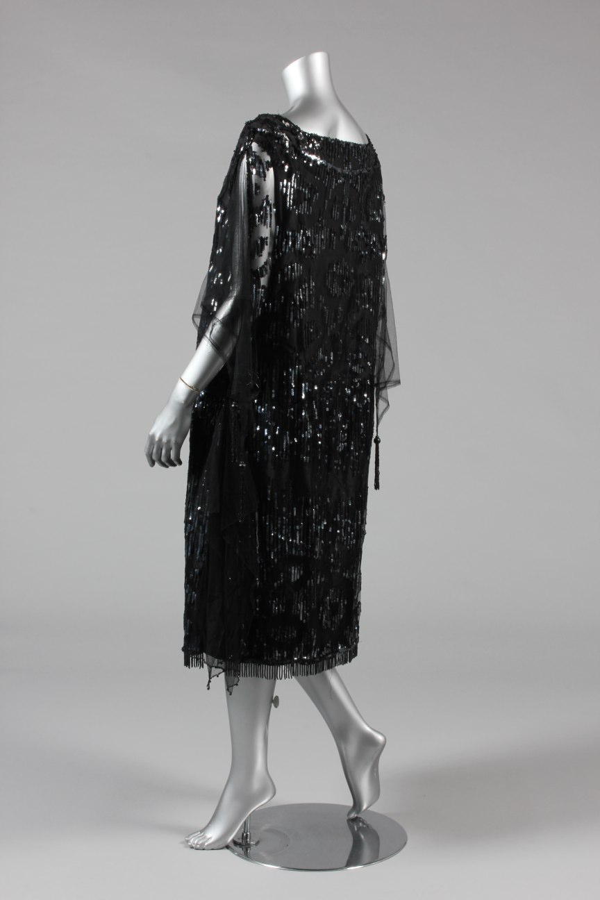 Lot 11 - A sequinned black tulle tabard dress, early