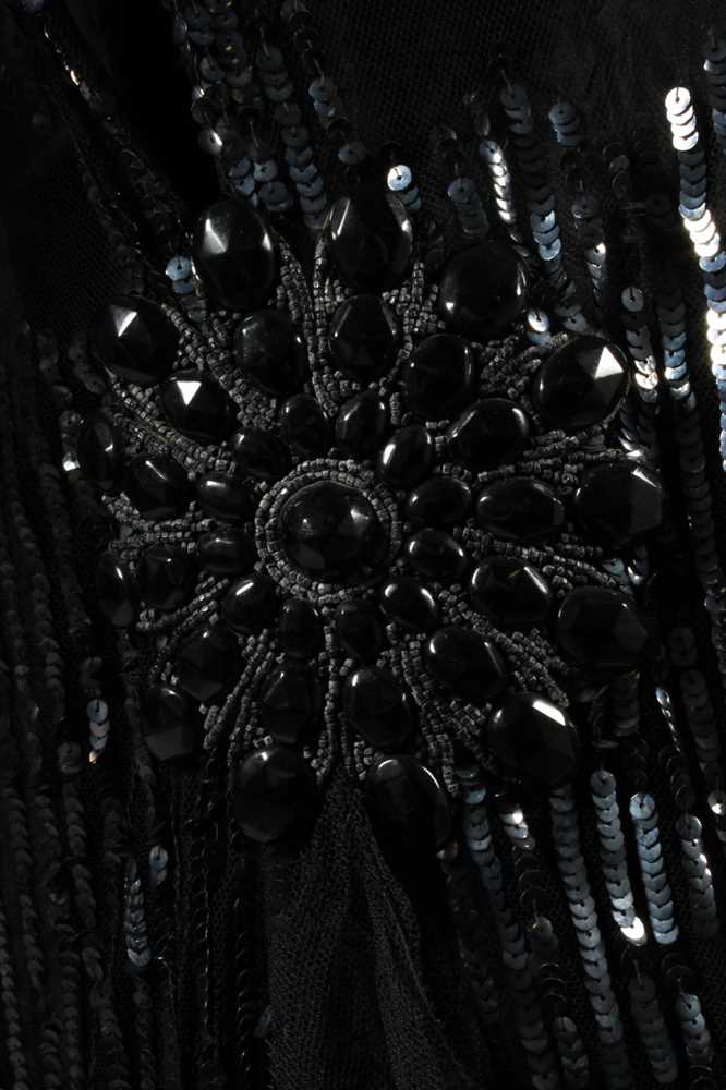 Lot 11 - A sequinned black tulle tabard dress, early