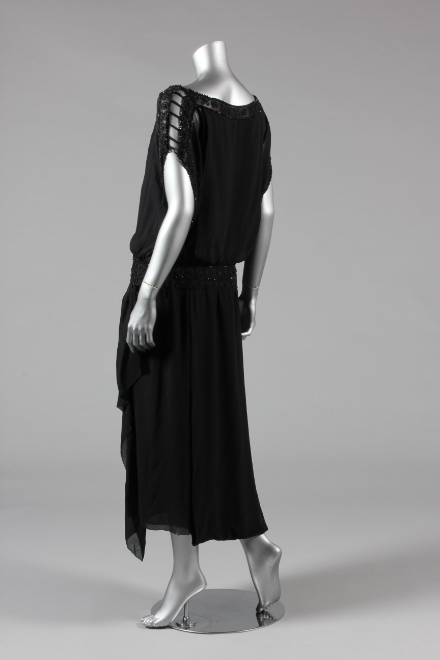 Lot 11 - A sequinned black tulle tabard dress, early
