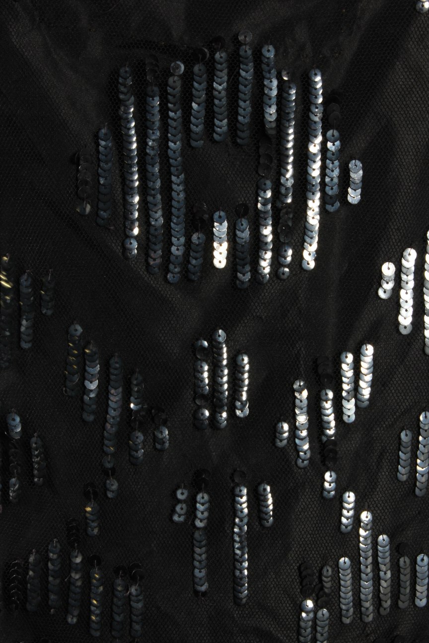 Lot 11 - A sequinned black tulle tabard dress, early