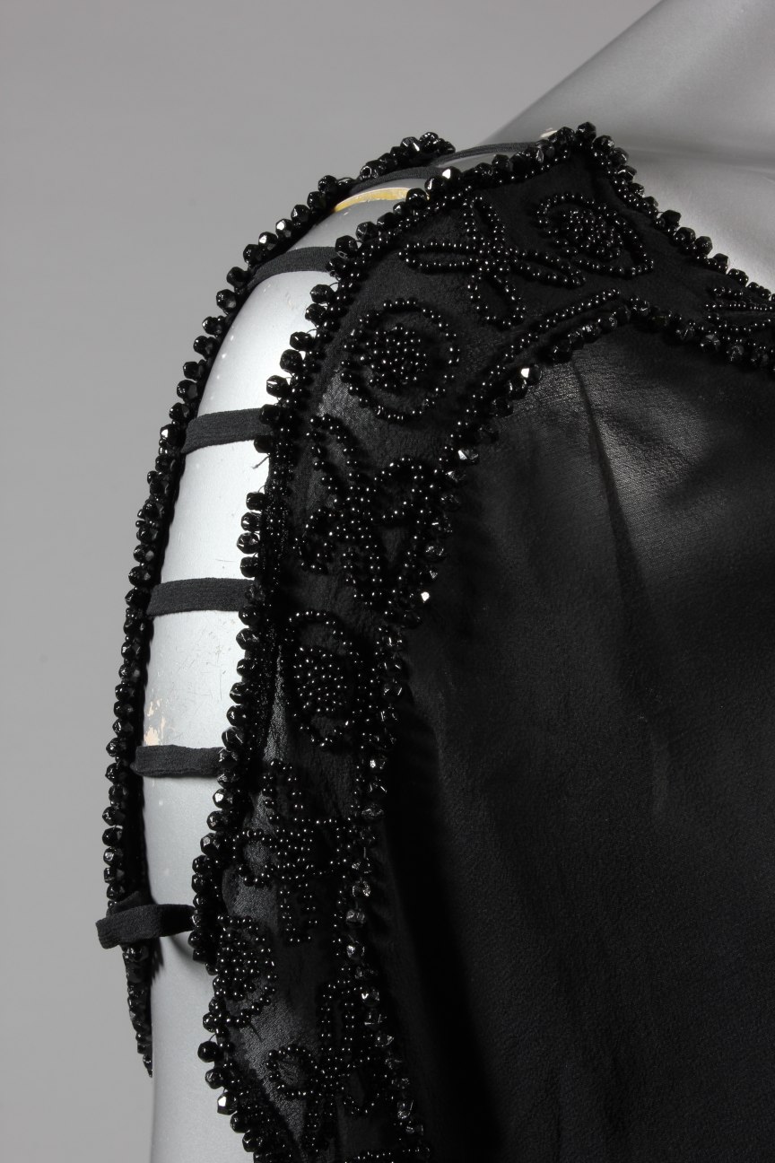 Lot 11 - A sequinned black tulle tabard dress, early
