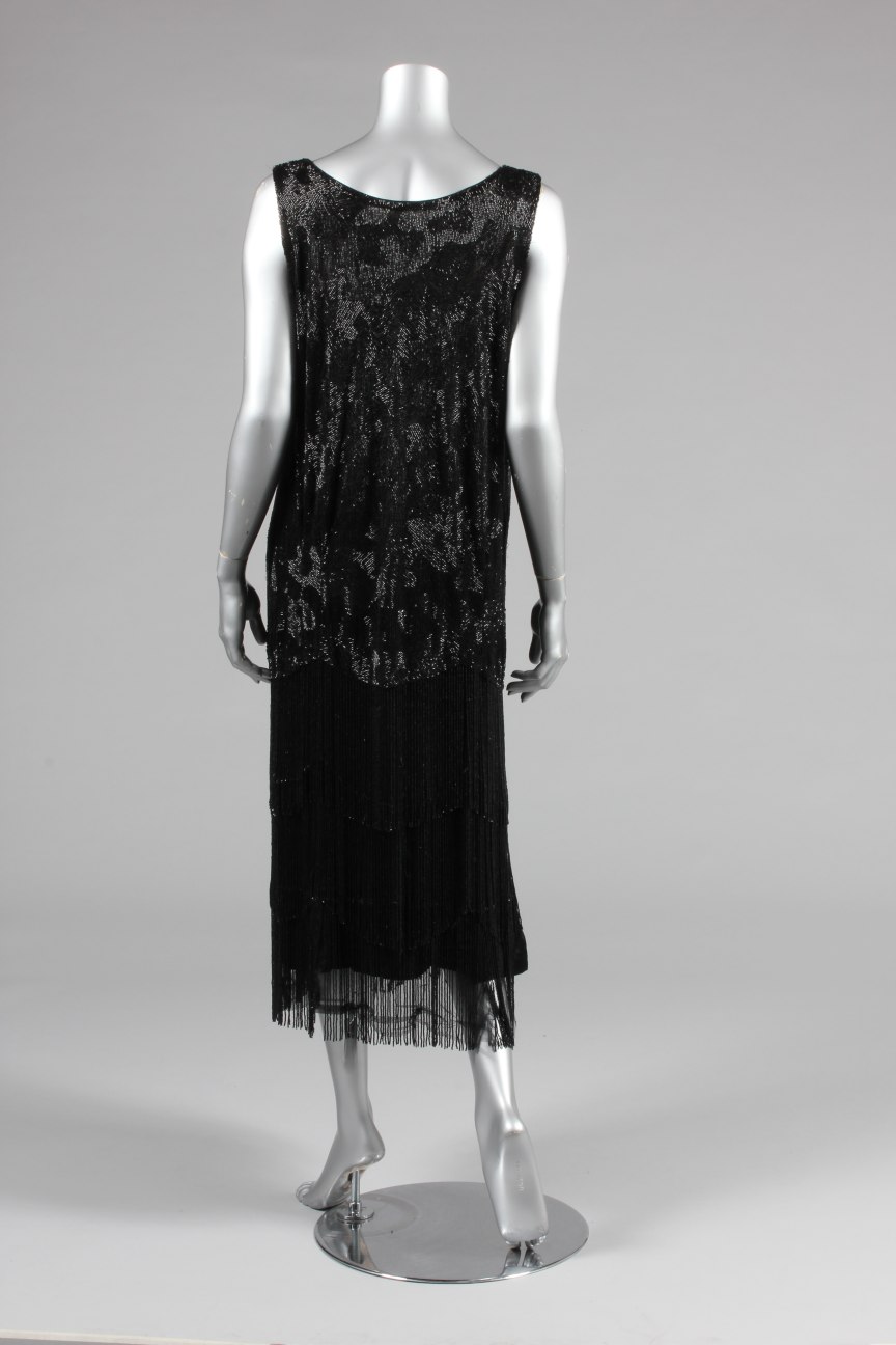 Lot 15 - A black beaded flapper dress, mid 1920s, the