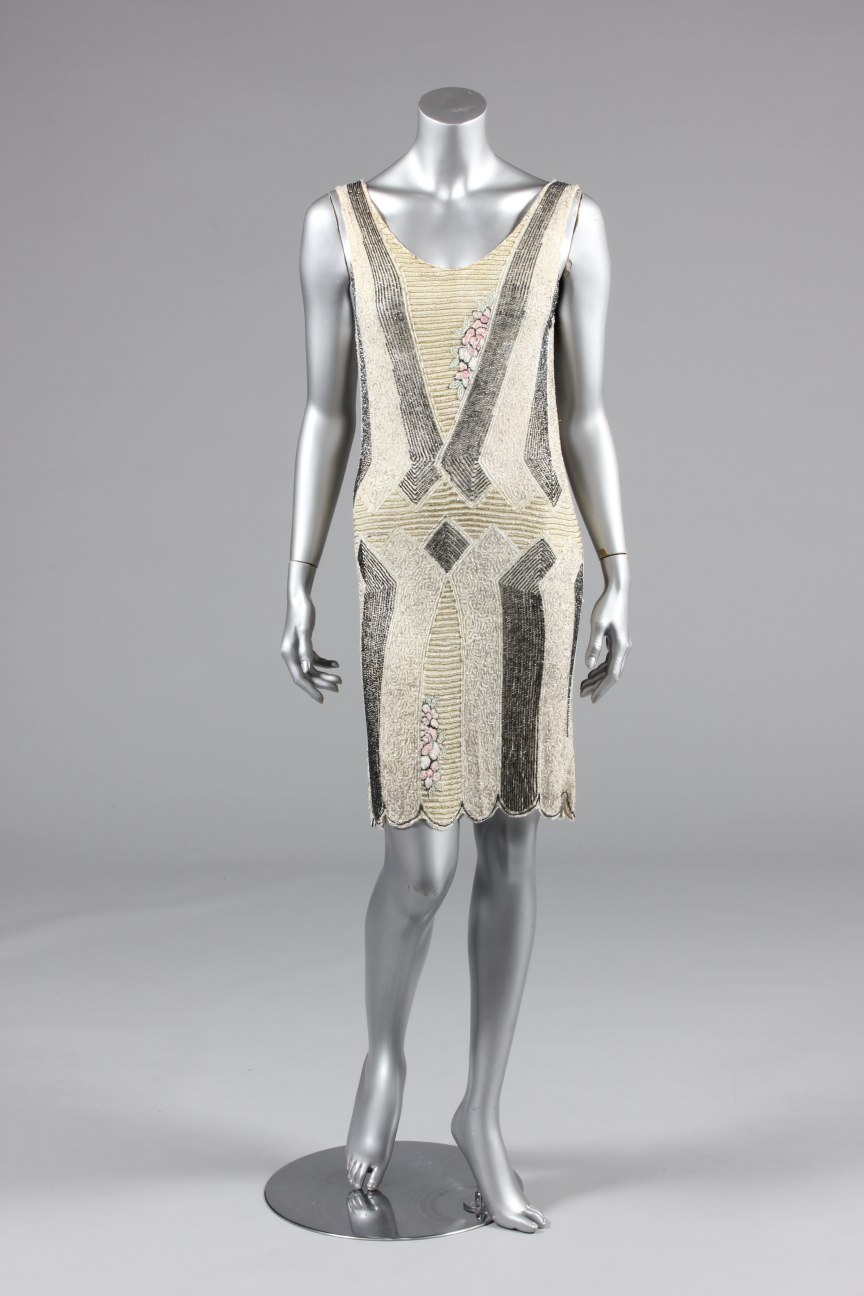 Lot 24 - A beaded tunic-dress, late 1920s, of midnight-