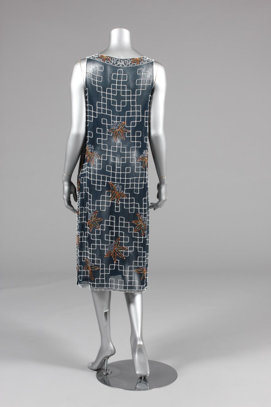 Lot 24 - A beaded tunic-dress, late 1920s, of midnight-